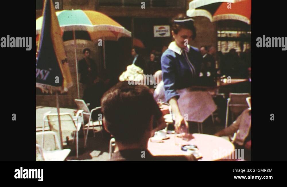 UNITED STATES: 1960s: waitress pours drink for customer. Man and lady ...