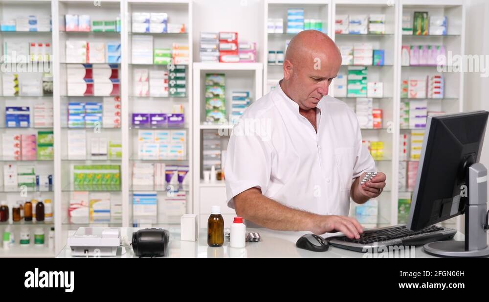 Pharmacy Store Employee Check Medicines Stock Using Computer Accessing ...