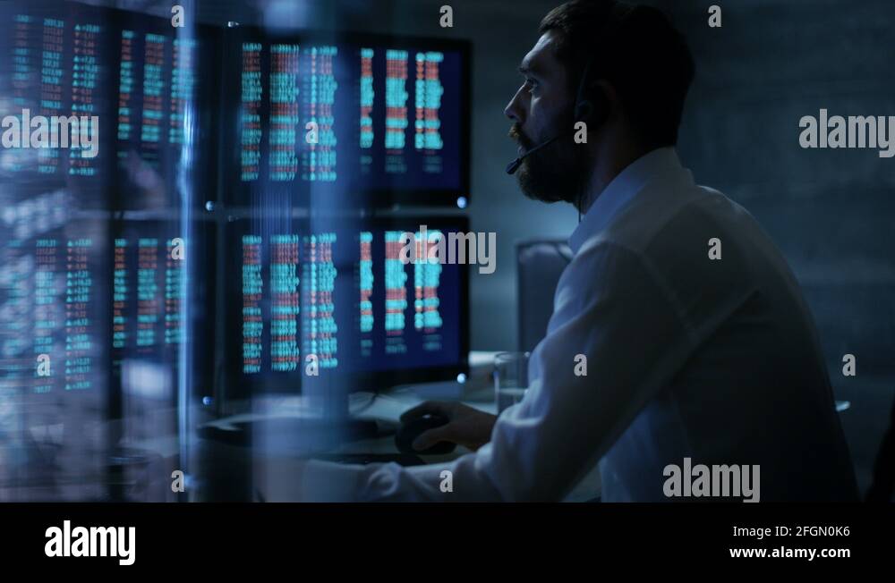 Late at Night Trader Reads Numbers on His Multiple Displays with Stock ...