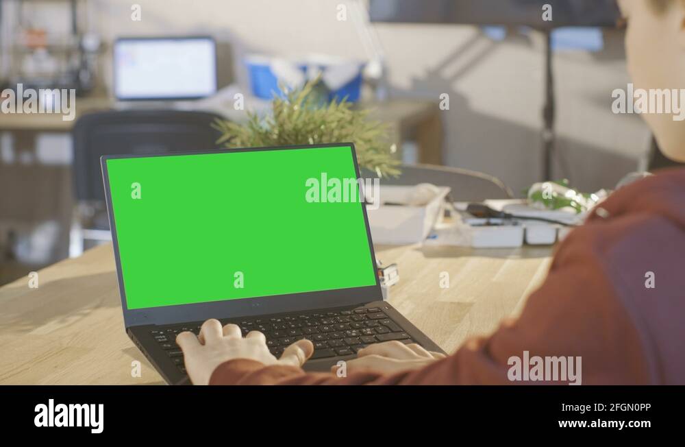 Smart Boy Uses Laptop with Mock-up Green Screen in His Computer Science ...