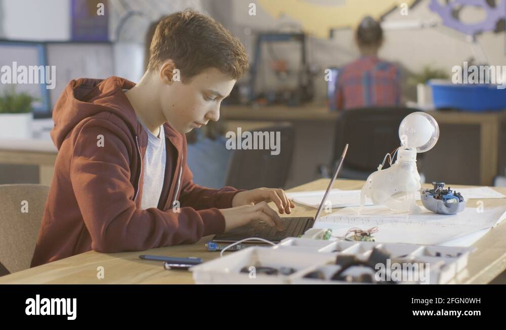Smart Young Boy Works on a Laptop For His New Project in His Computer ...