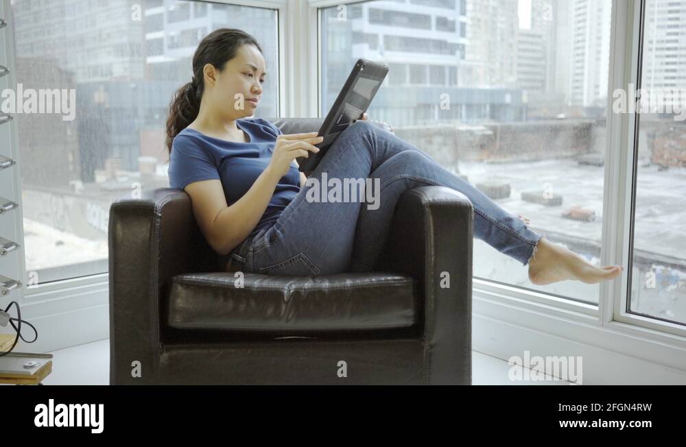 Woman in her 30s inside a modern condominium in downtown toronto ...