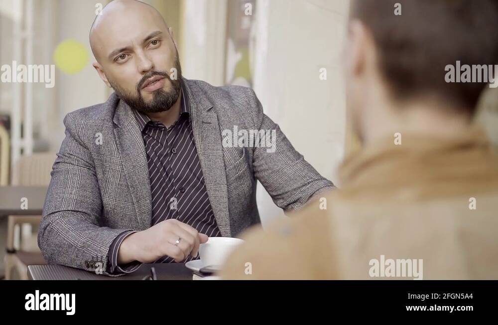 Male businessman with a beard and a bald an interview with the new ...