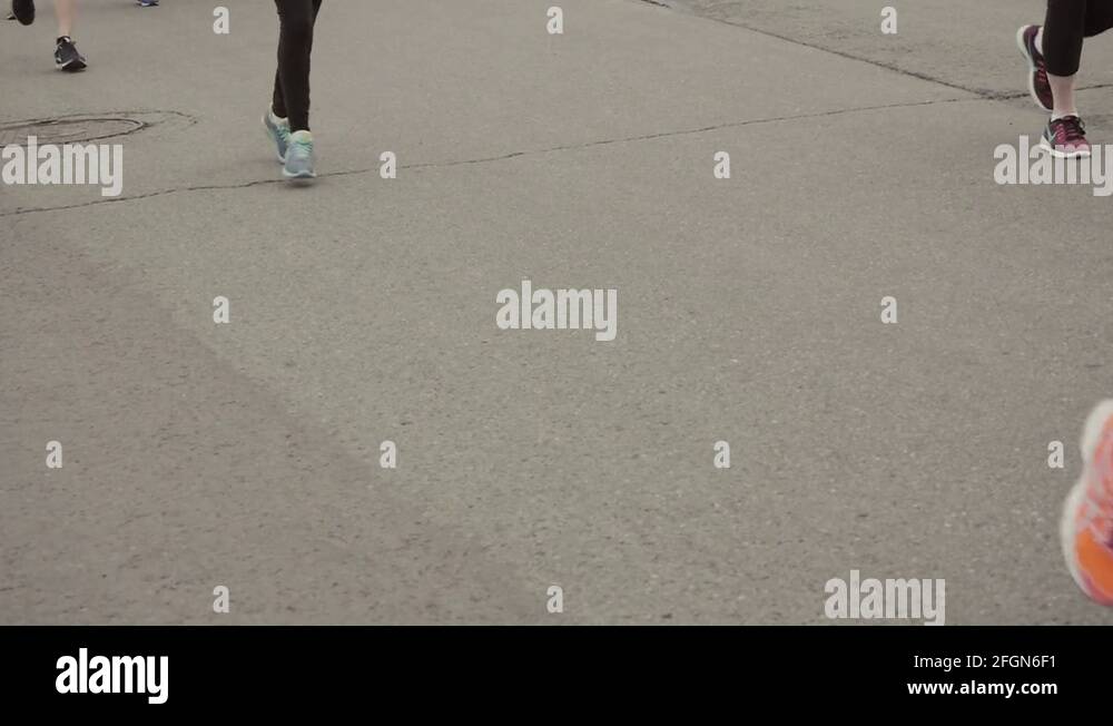 Unidentified marathon athletes legs running on city road, sport legs ...