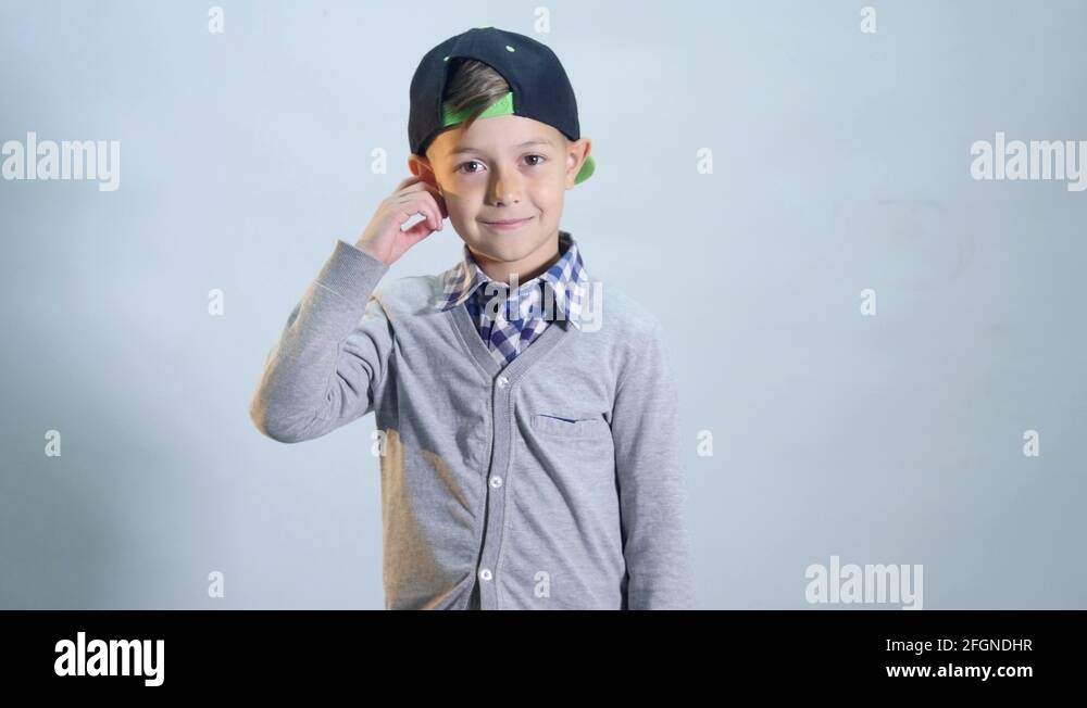 A boy with a toothless smile picks his ear Stock Video Footage - Alamy