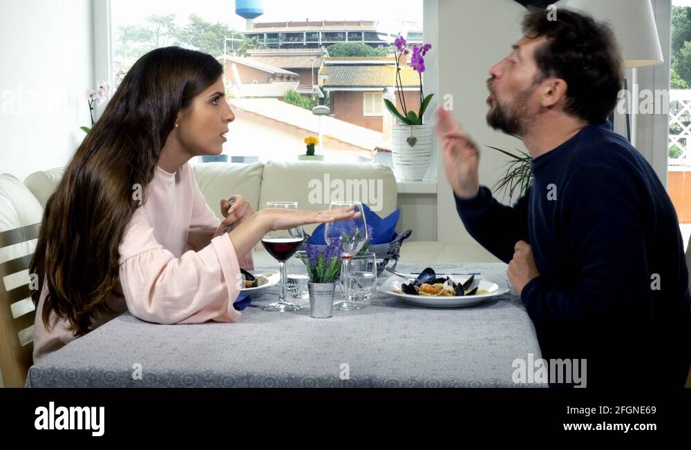 Man and woman shouting and screaming at each other angry during lunch ...