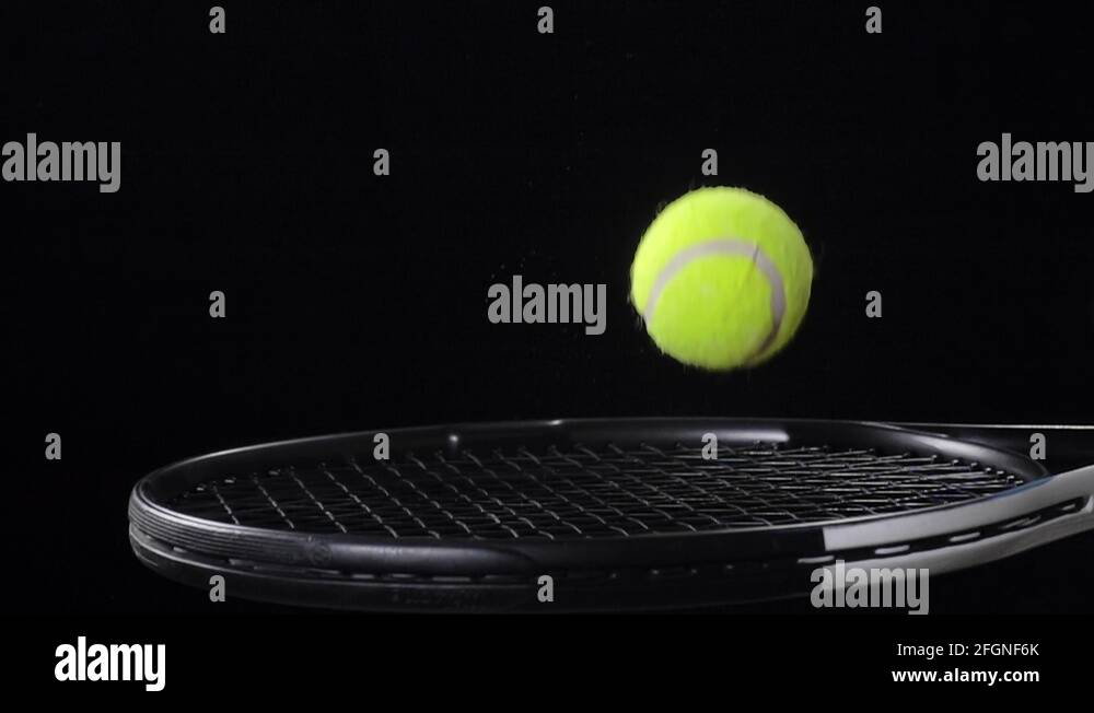 tennis ball bouncing on racket slow motion black background Stock Video ...