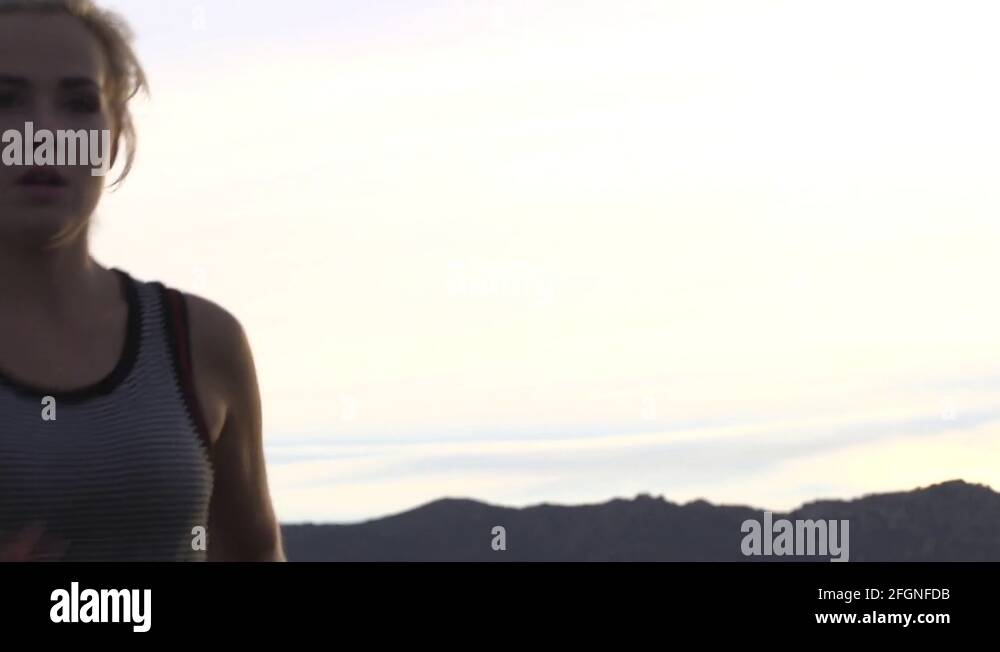 Pan left female model running at sunset Stock Video Footage - Alamy