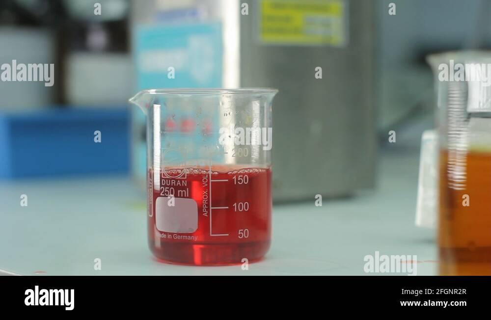Lab worke stirring liquid Stock Video Footage - Alamy