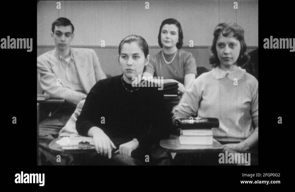 1950s: Male and female college students sit in classroom. Male ...