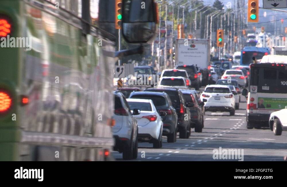 Public transit buses cars and traffic gridlock on city street in rush ...