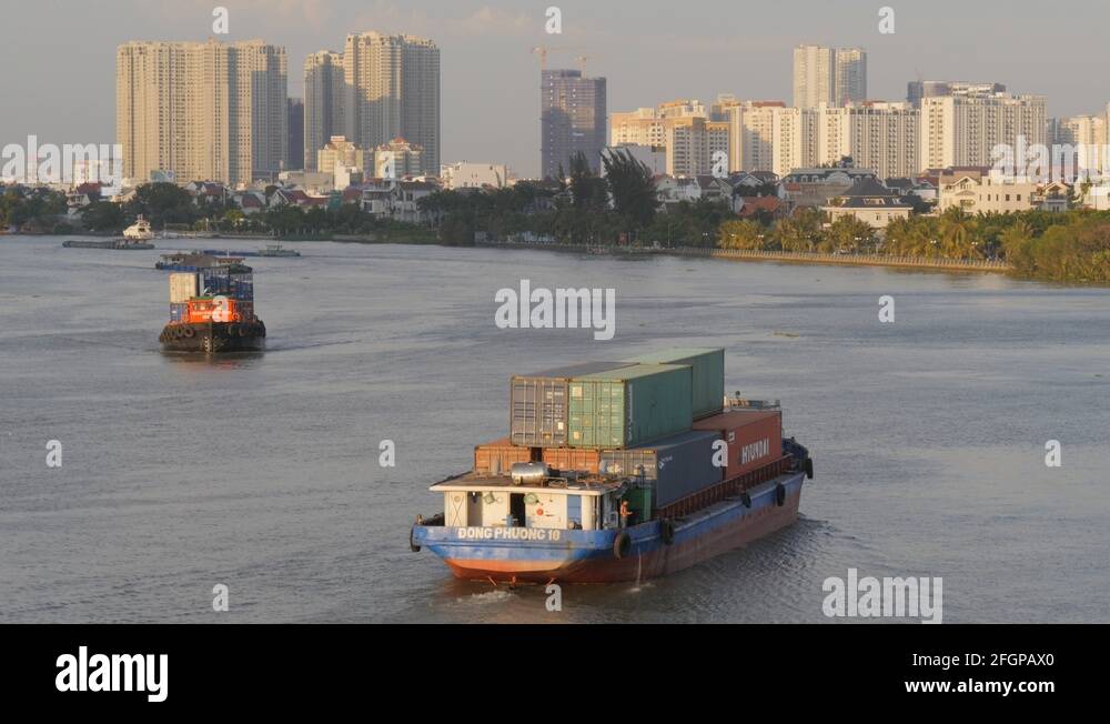 Container river transport boat with flat buildings,Saigon,Vietnam Stock ...
