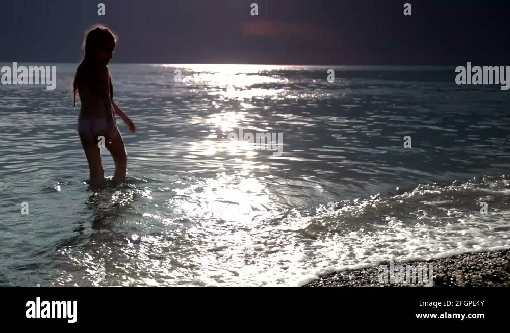 little girl on the sunset beach Stock Video Footage - Alamy