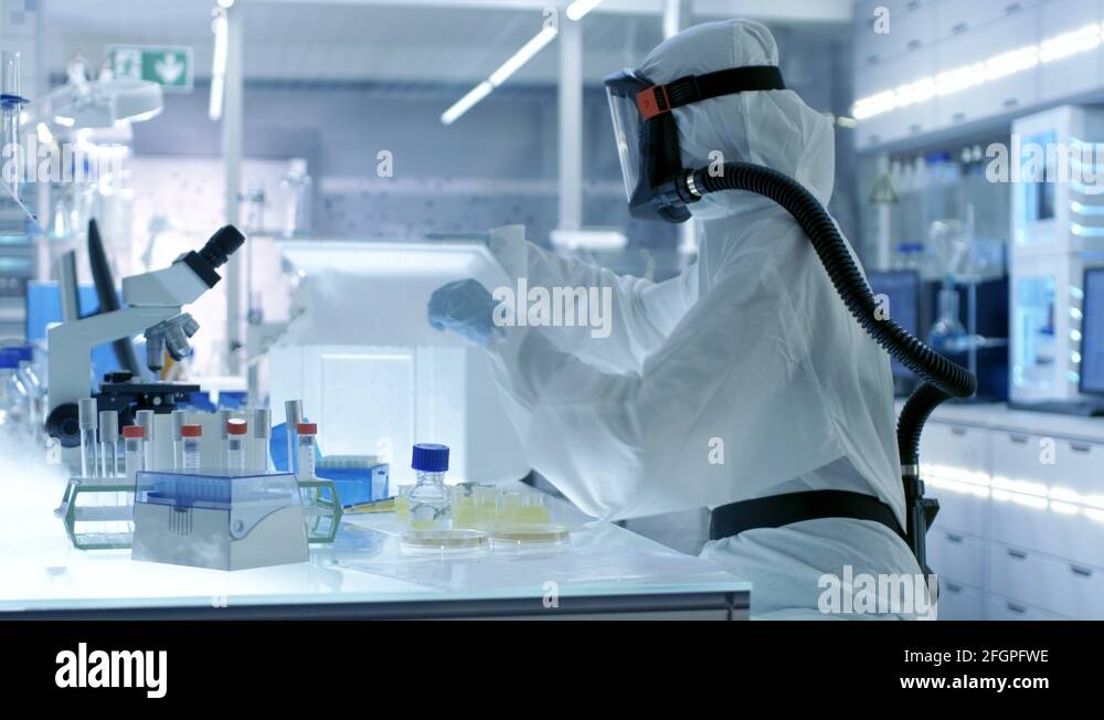 Medical Virology Research Scientist Works in a Hazmat Suit with Mask ...