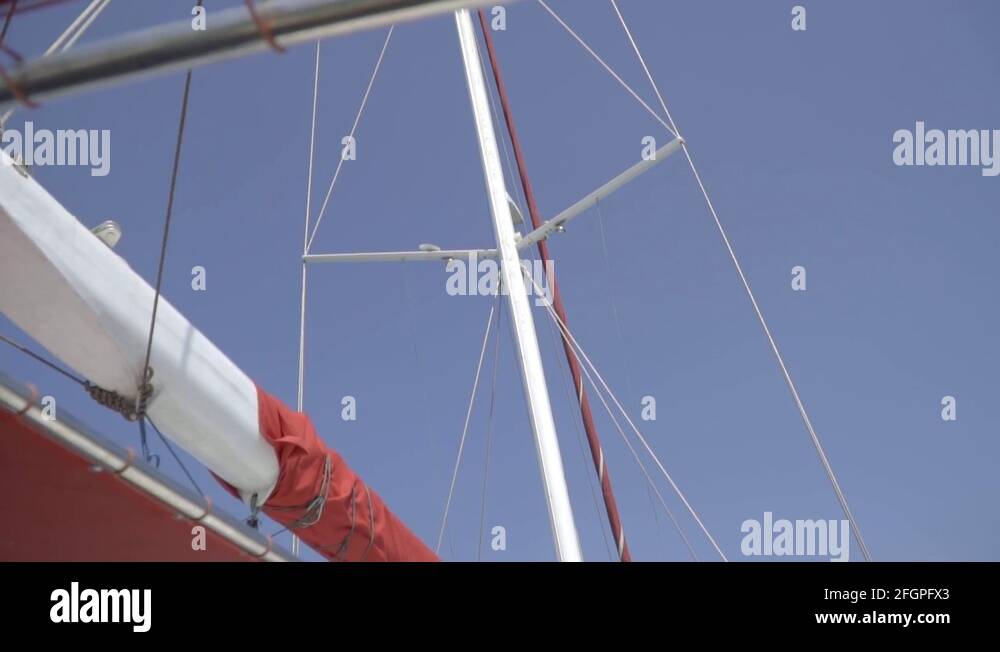 The red and white masts of a yacht amid the blue sky Stock Video ...