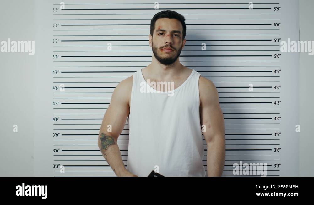 In a Police Station Arrested Beaten Man Poses for Side, Front View ...