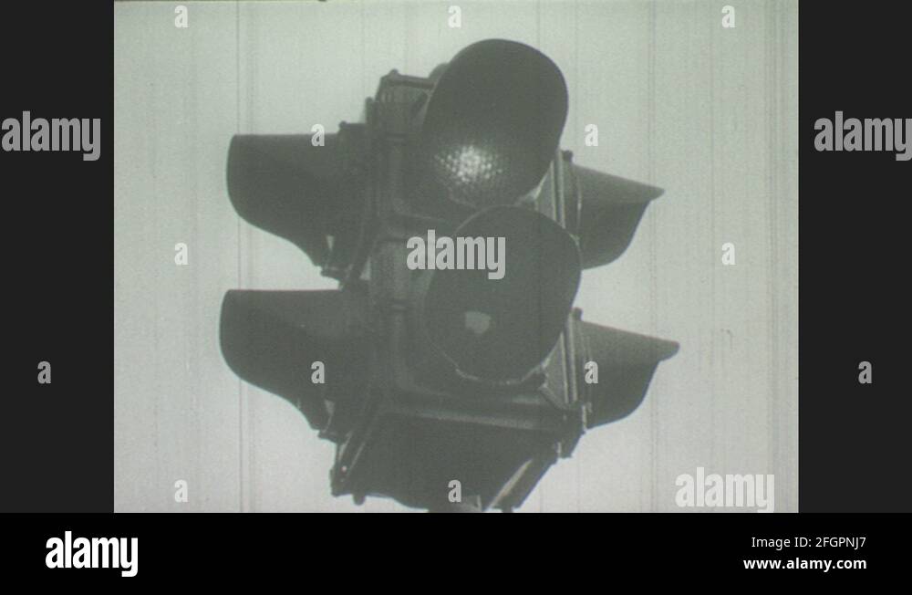 1940s: A stoplight. An intersection. Cars stop at intersection. Light ...