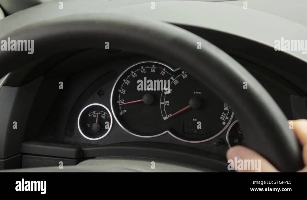 Woman starts the engine. tachometer with the pointer going to maximum ...