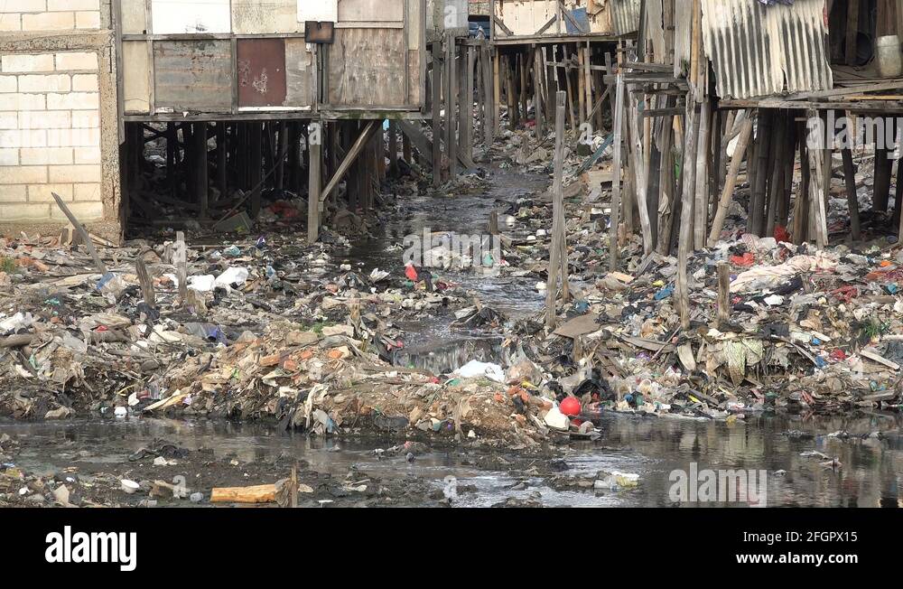 Garbage has been dumped in shallow stream in slums of Jakarta ...