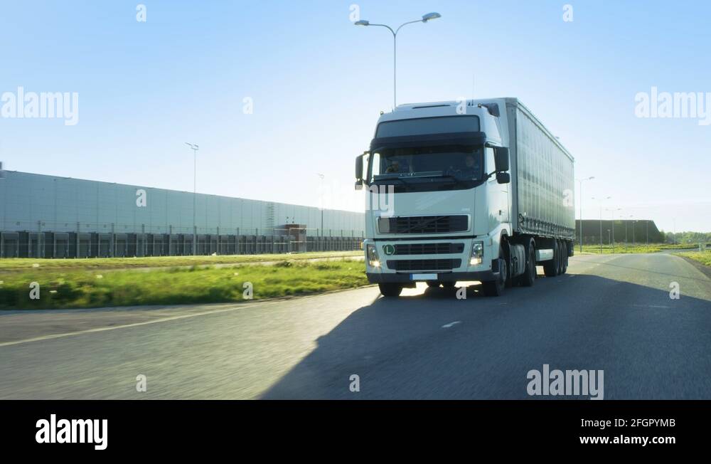 Front-View Camera Follows Semi Truck with Cargo Trailer Driving on a ...