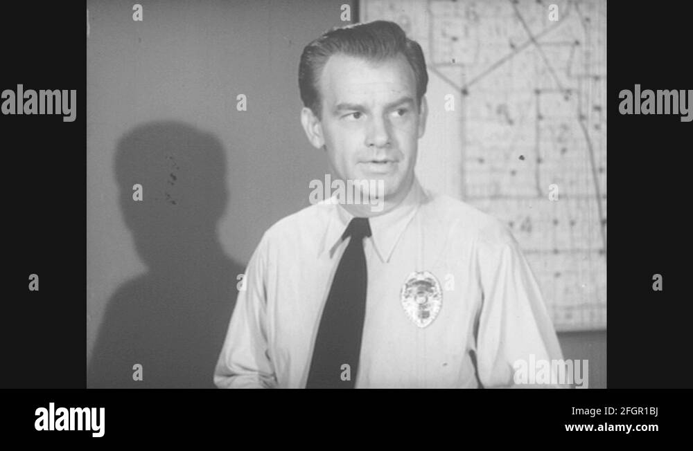 1950s: Police officer and Sergeant talk. Sergeant reads from a citation ...