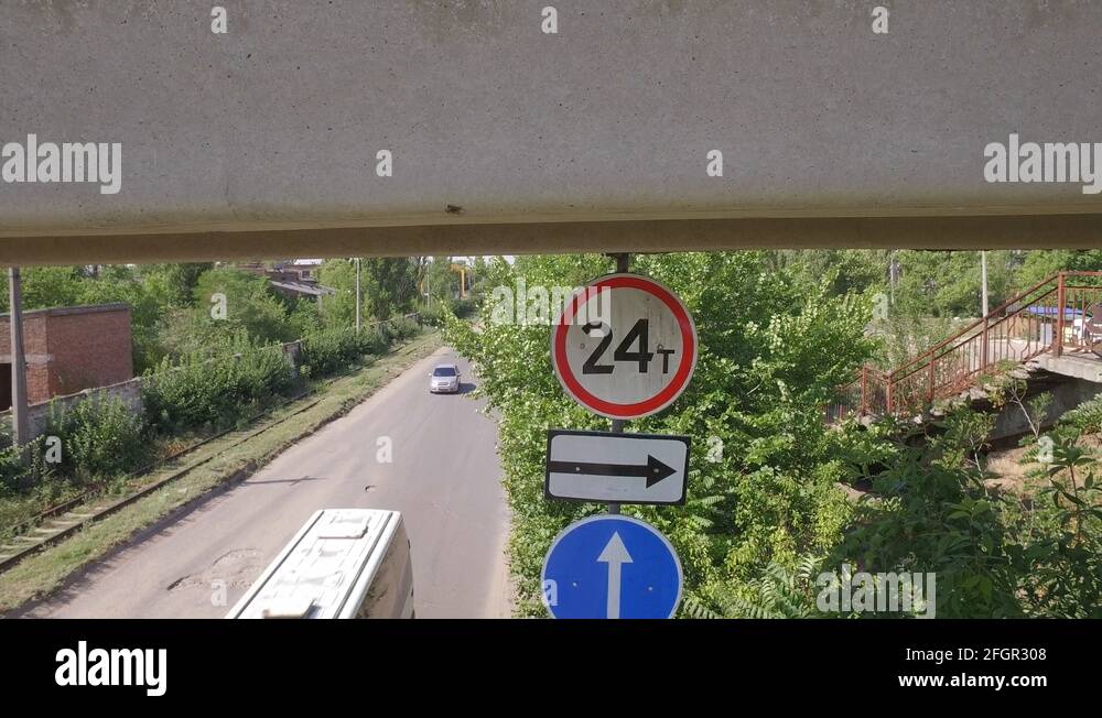 Road signs on a concrete pedestrian bridge across highway in suburbs ...