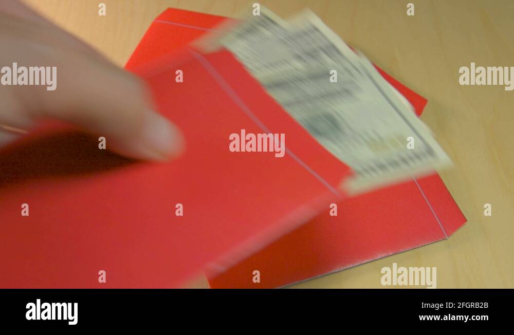 Giving a red envelope or hong bao with dollar bills in Chinese New year ...