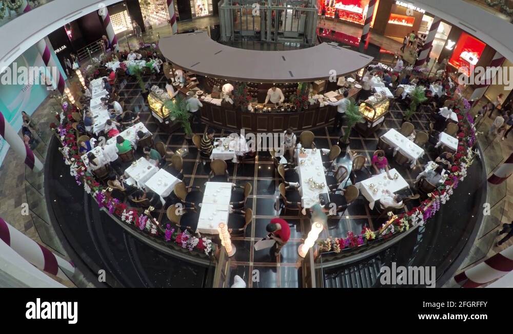 Guests enjoy fine dining in atrium restaurant at Shoppes at Marina Bay ...