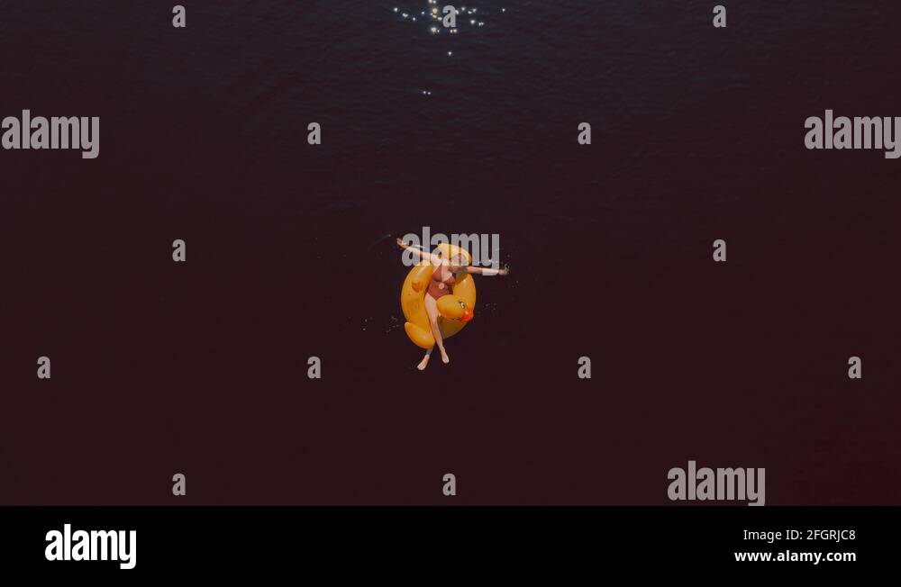 Beautiful woman relaxing on an inflatable raft in the ocean Stock Video ...