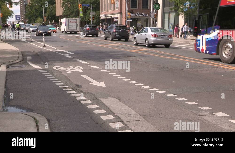 Bike lanes and bicycles alongside car traffic on urban Toronto streets ...