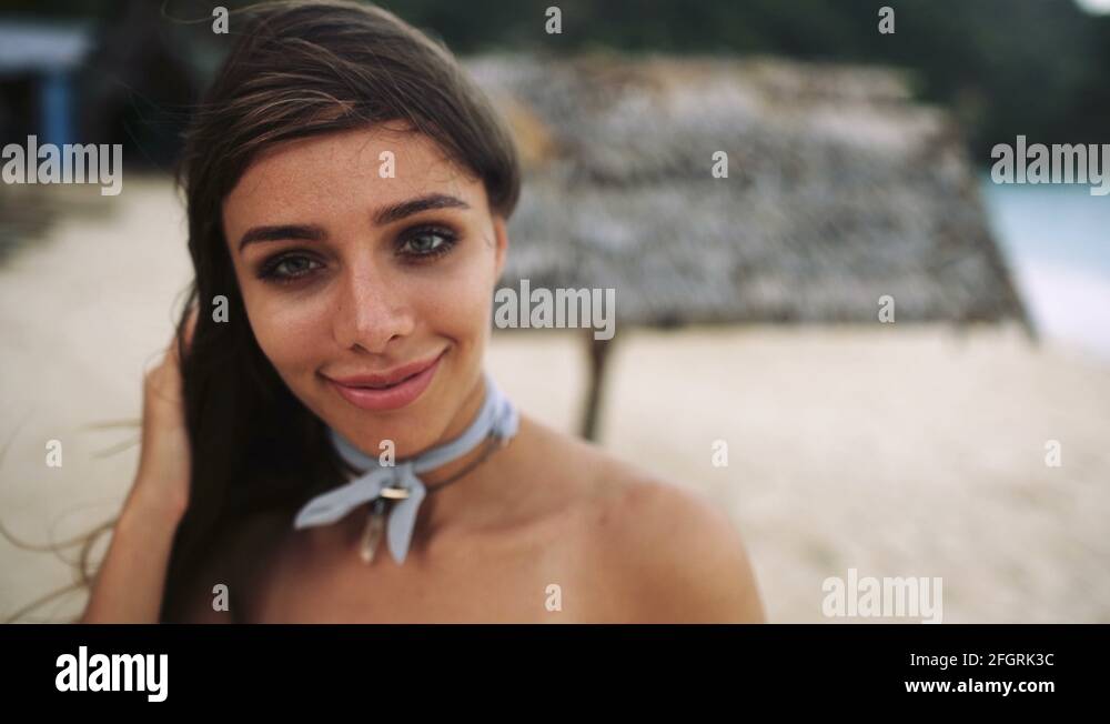 Sexy girl with beautiful smile and long hair laughing on the beach ...