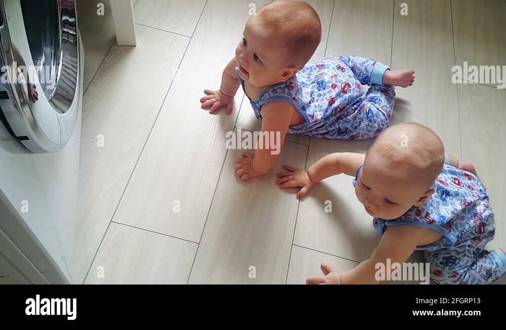 Two little child watching with interest the washing machine Stock Video ...