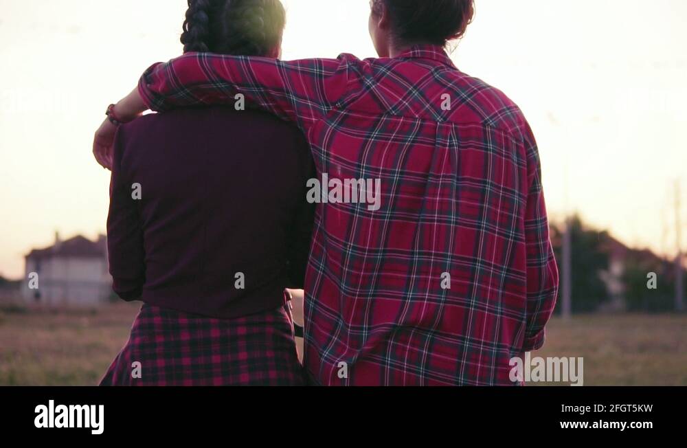 Back view of two best friends hugging each other. Happy young woman hug ...