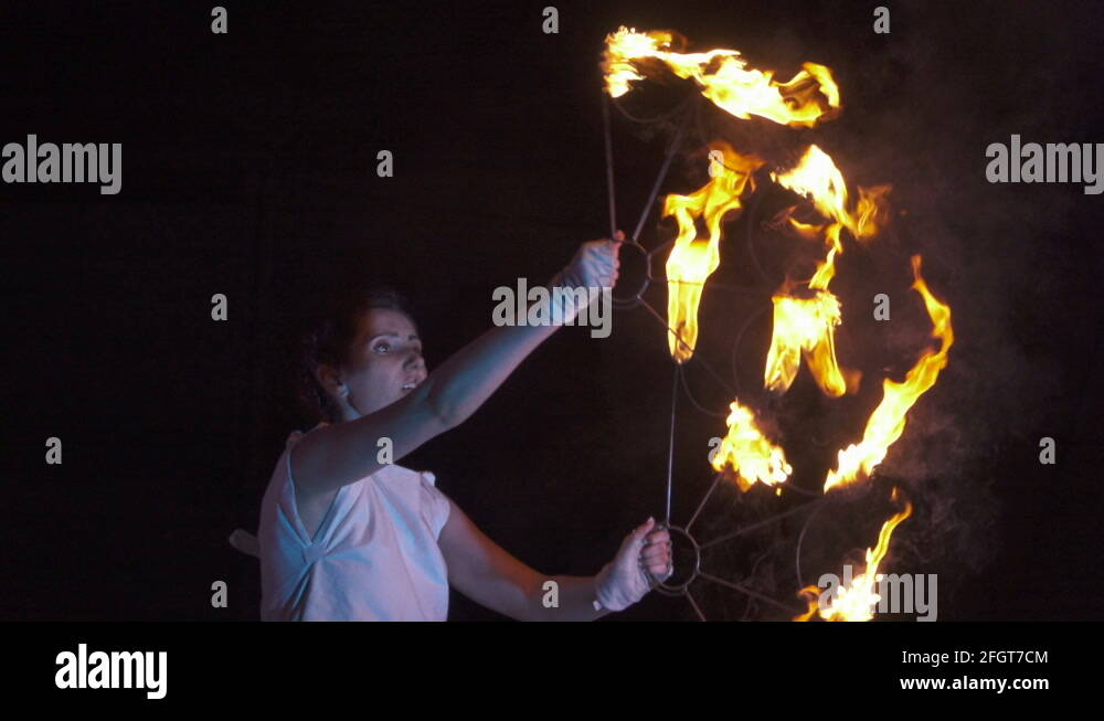Fiery dance. Amazing magical Fire Show at night. Slow shutter speed ...