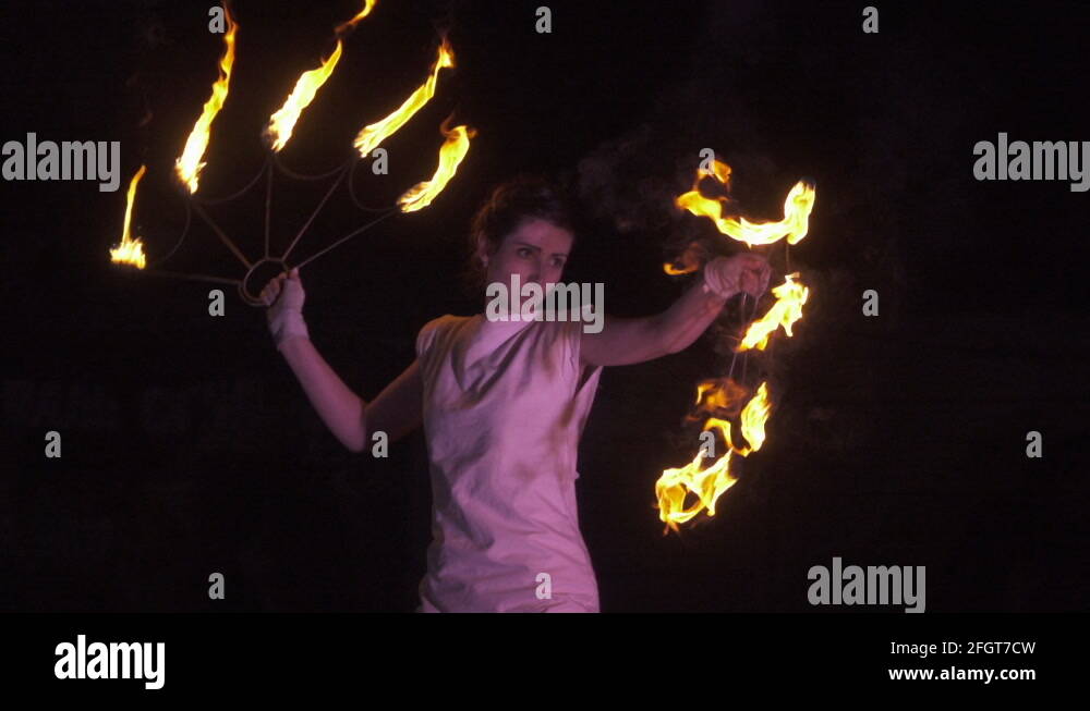 Fiery dance. Amazing magical Fire Show at night. Slow shutter speed ...