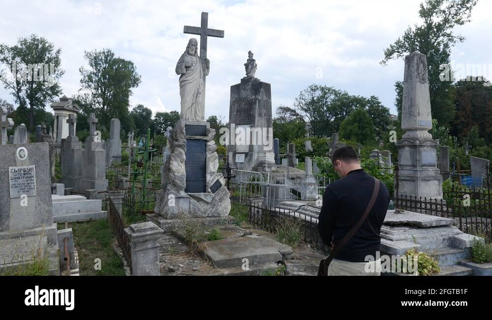 Man Crying In Tomb Of A Cemetery. Desperate young man crying in tomb of ...