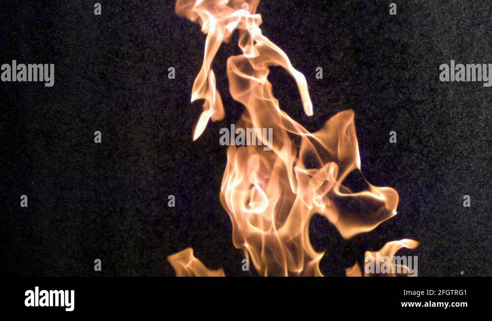 Fire flames rising up against black background in slow motion Stock ...