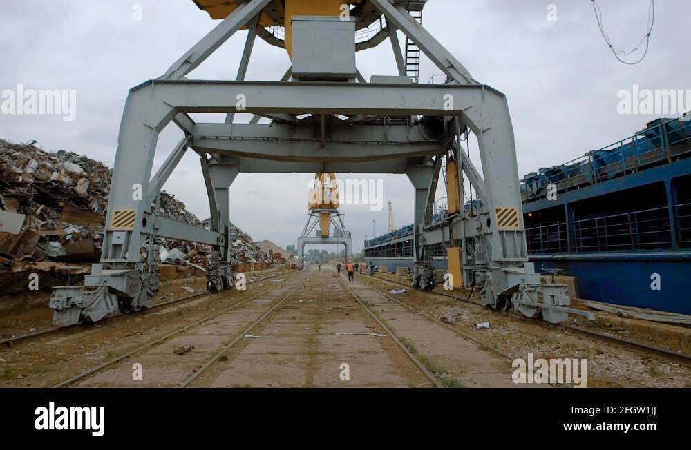 huge industrial crane are standing in a wrecking yard of a scrap metal ...