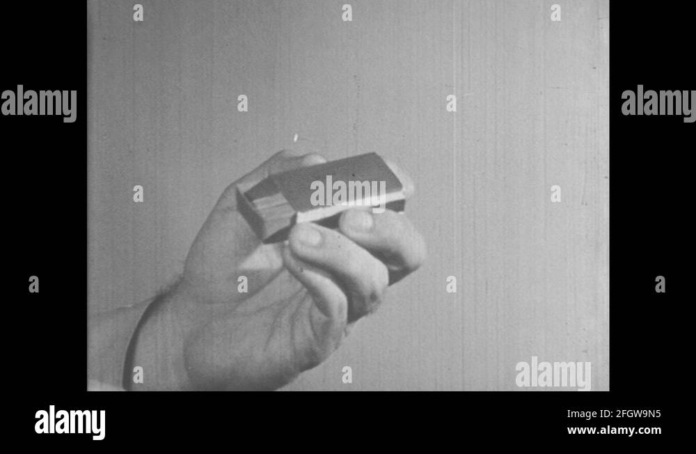1950s: UNITED STATES: hand opens box of safety matches. Fingers strike ...