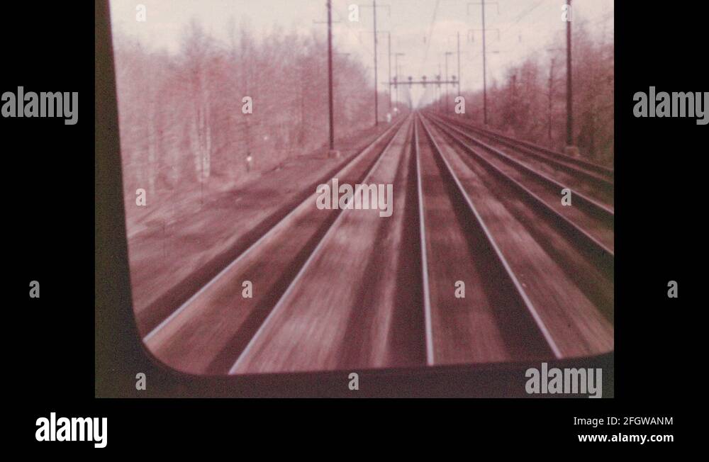 1970s: Tracks moving beneath train. Blurred tracks and trees alongside ...