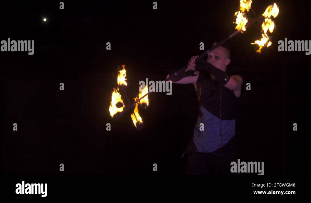 Fiery dance. Amazing magical Fire Show at night. Slow shutter speed ...