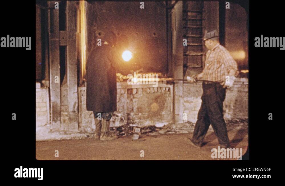 1950s: Men pull molten metal from furnace. Hands pull out metal rods ...