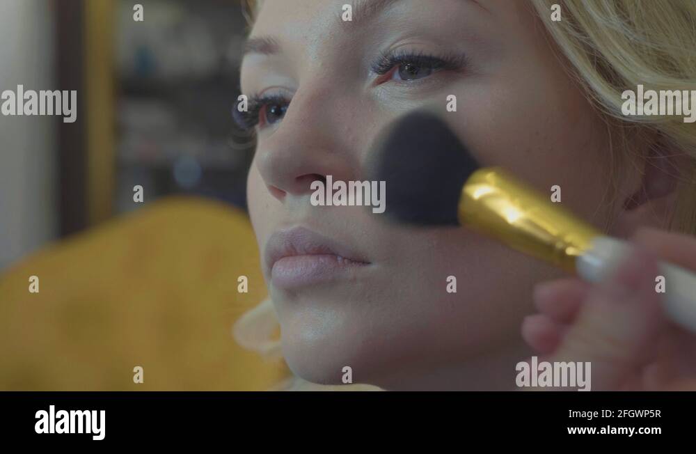 Young makeup artist applying concealer on model's face Stock Video ...