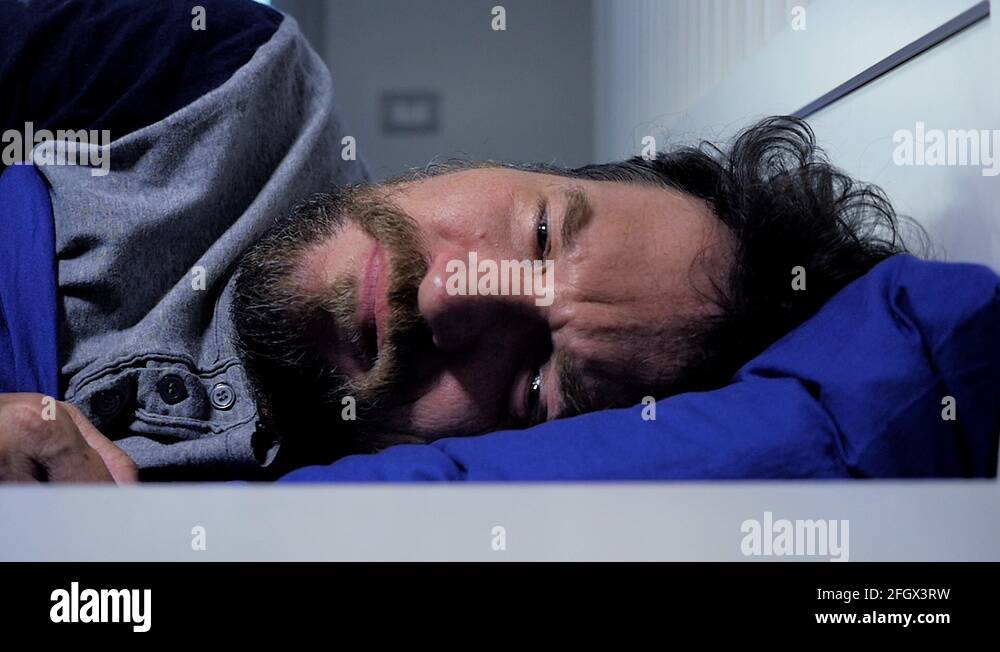 Sad man crying in bed slow motion Stock Video Footage - Alamy