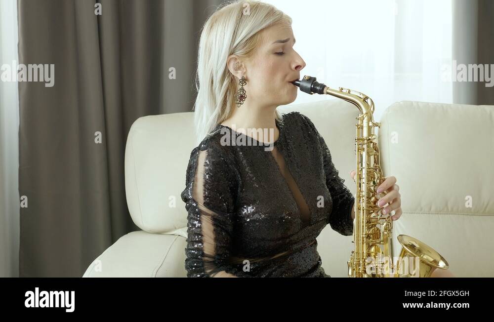 Jazz saxophone player performing on the sax in the living room Stock ...