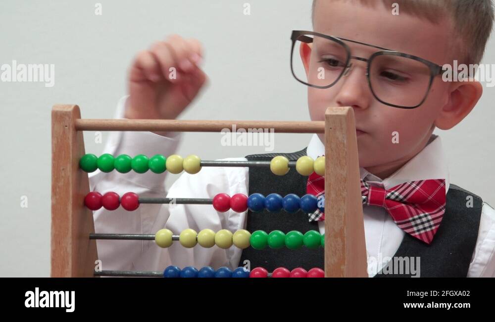 Portrait of funny little child with big eyeglasses numbering, wooden ...