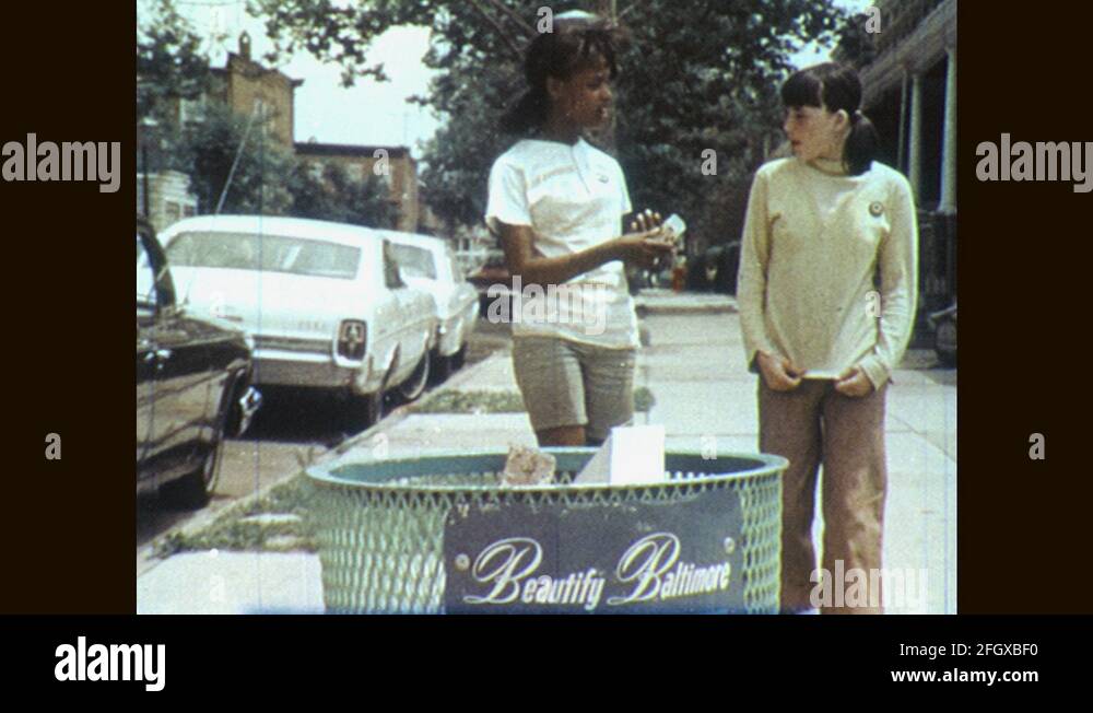 1960s: Girls throw trash in garbage can marked with Beautify Baltimore. Man Stock Video Footage ...