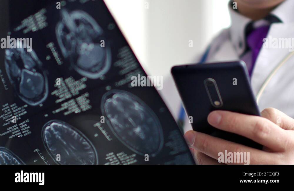Medical doctor view MRI scan and typing SMS to somebody. 4K UltraHD ...
