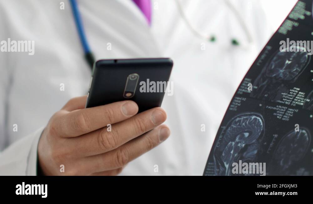 Medical doctor view MRI scan and typing SMS to somebody. 4K UltraHD ...