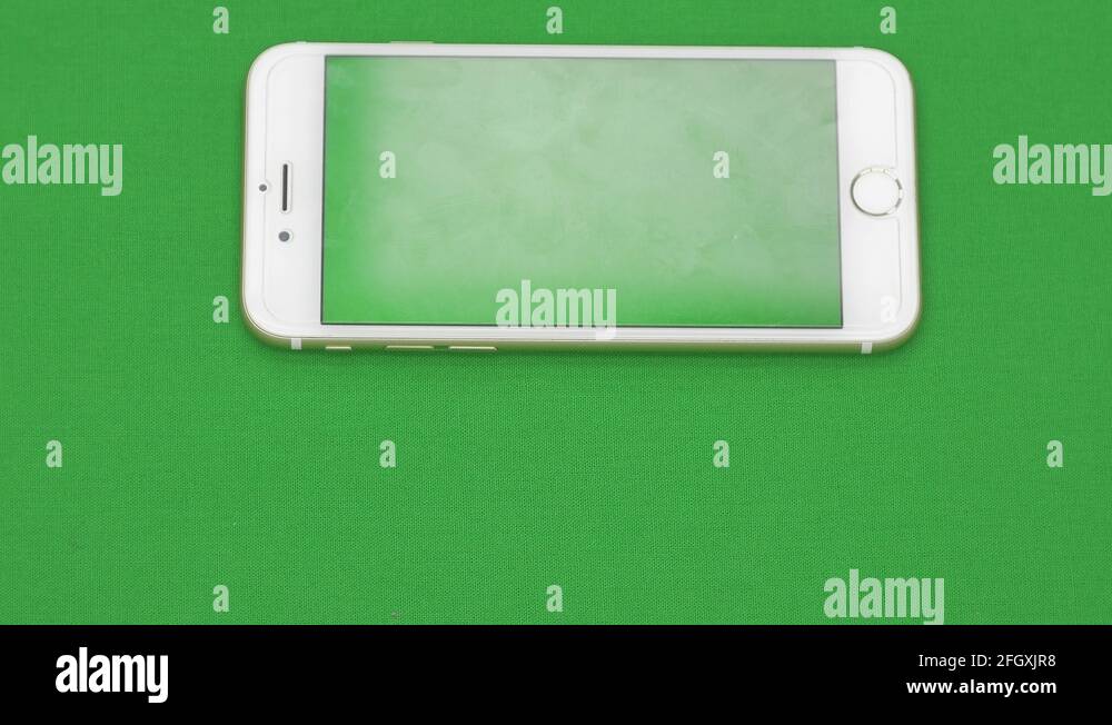 Using smart phone on green screen with various hand gestures ...